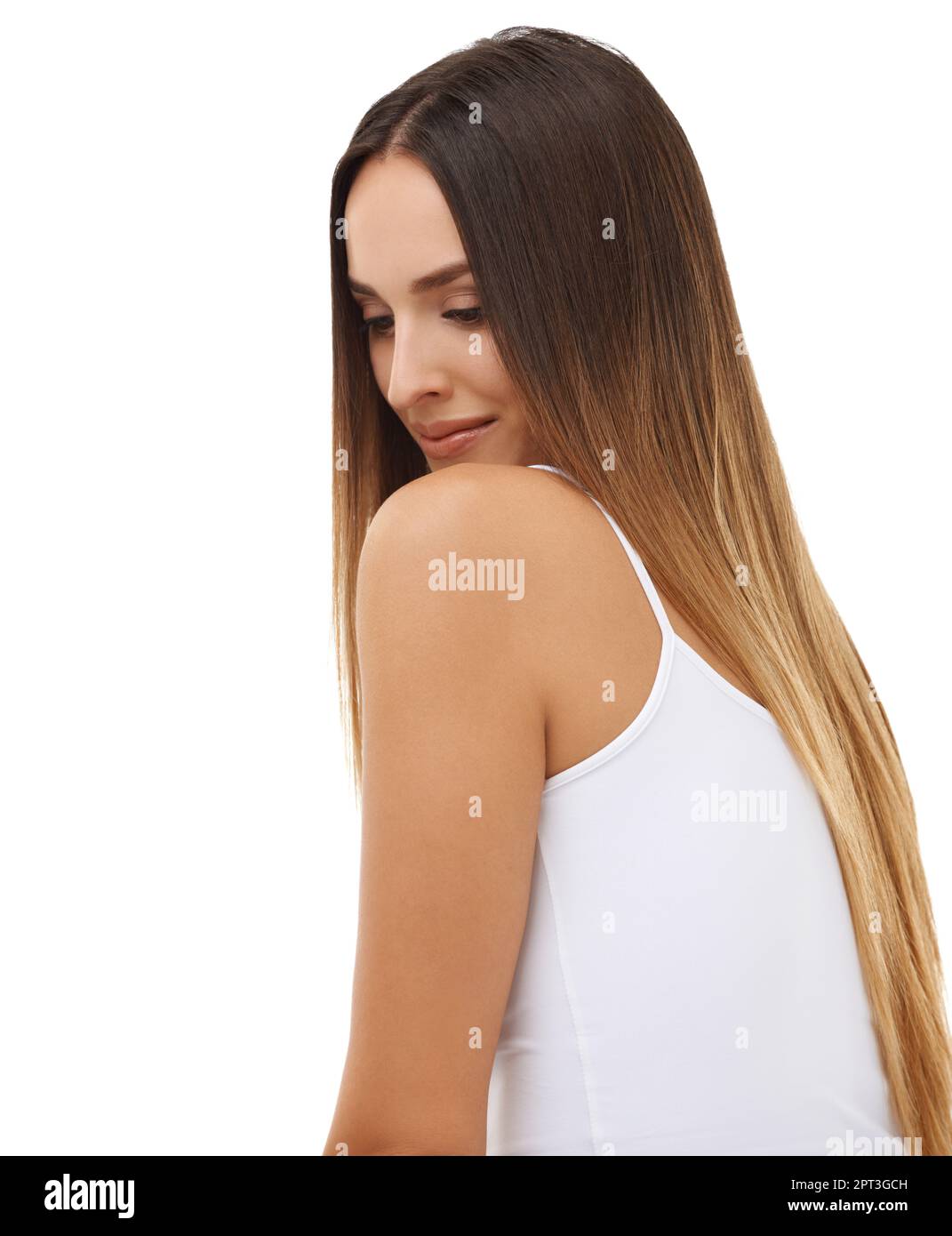 Sweet and shy. Studio shot of a beautiful young woman with long hair ...