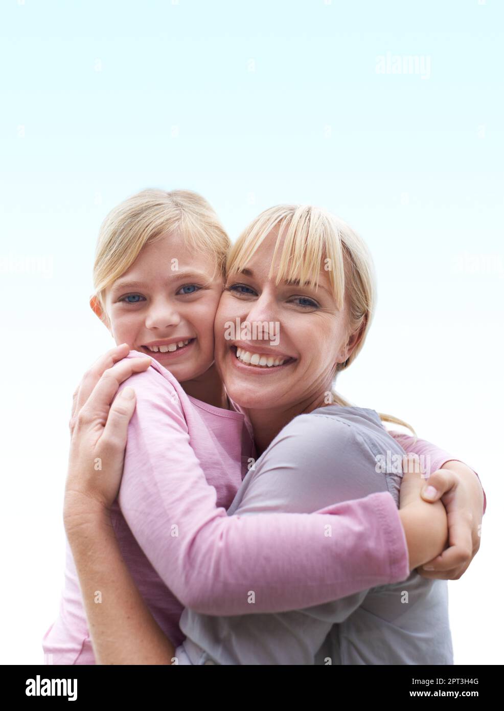 Theres nothing like a mothers love. A happy young girl giving her ...