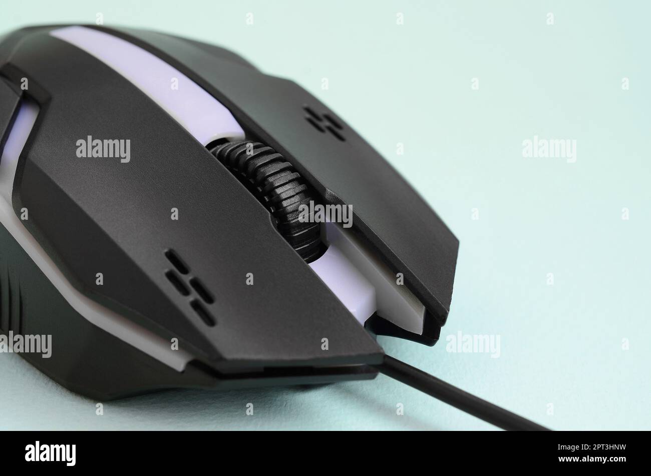 Closeup of a black gaming optical mouse on a blue background. Device ...