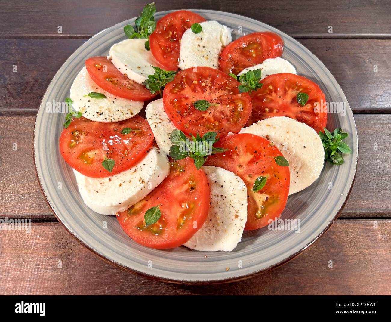 Tomato and mozzarella Caprese salad with sauce Stock Photo - Alamy