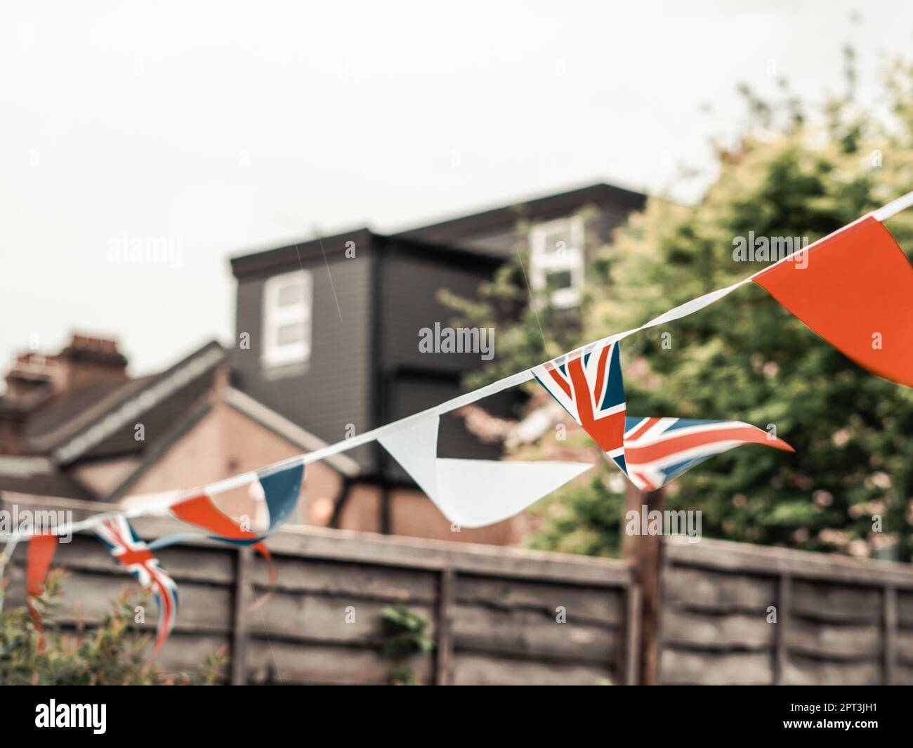 Flags of Great Britain waving on the wind in the garden of English ...