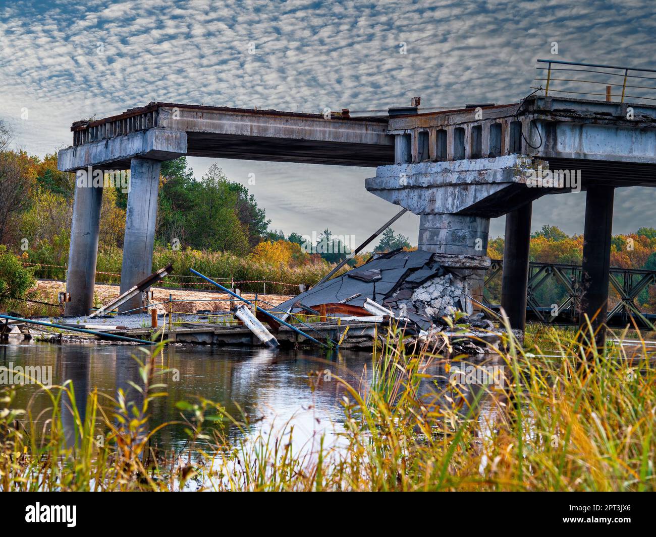 Destroyed automobile reinforced concrete bridge across the river ...