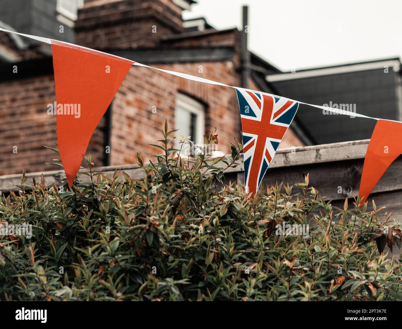 Flags of Great Britain waving on the wind in the garden of English ...