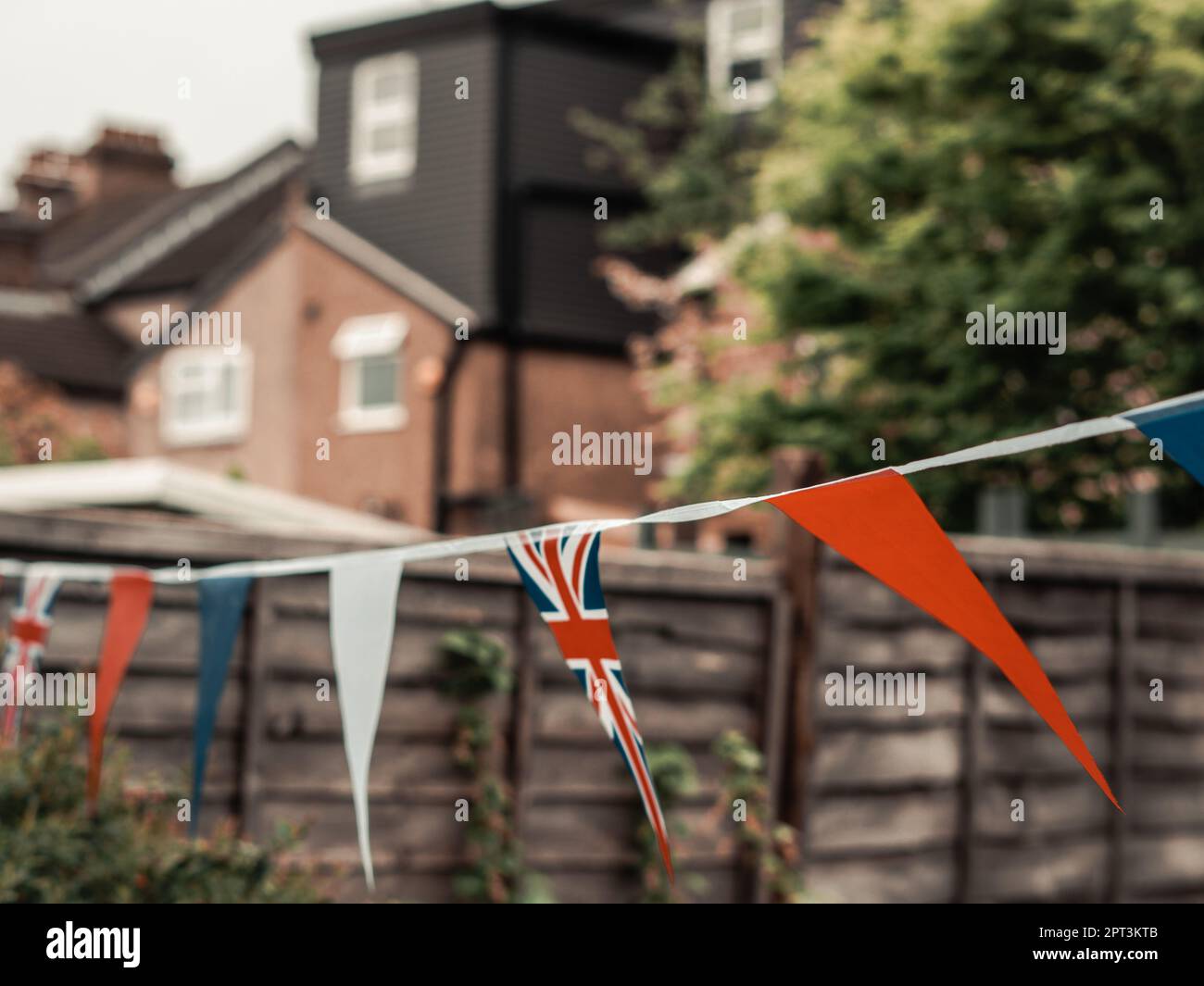 Flags of Great Britain waving on the wind in the garden of English ...