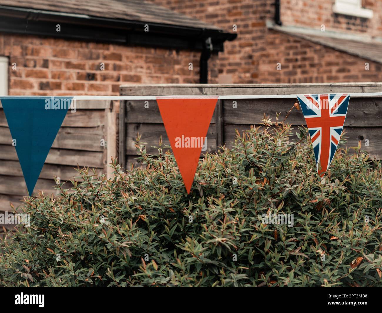 Flags of Great Britain waving on the wind in the garden of English ...