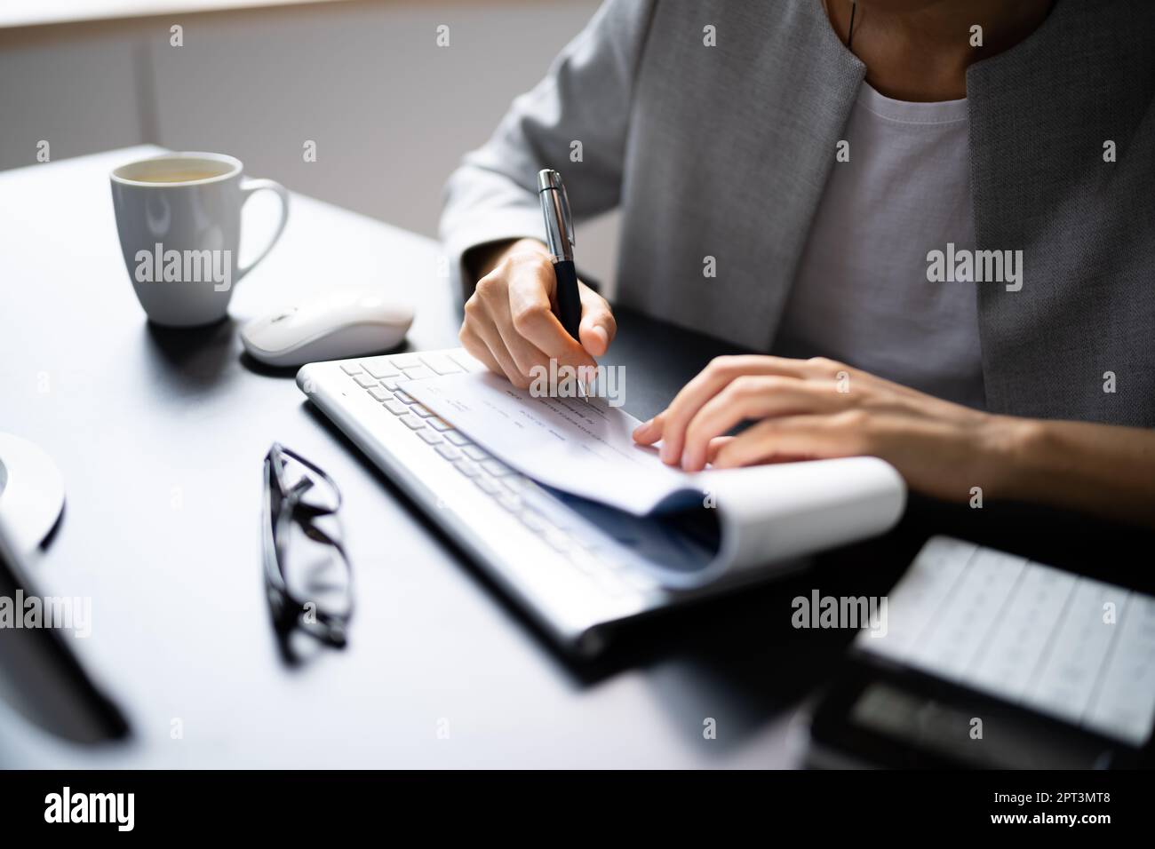 African Woman Signing Bank Check Or Paycheck Stock Photo - Alamy