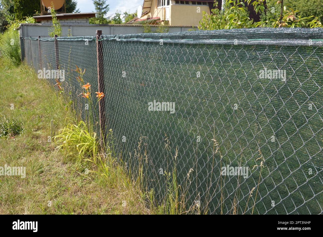Installation of a shading net on a the chain-link fence Stock Photo - Alamy