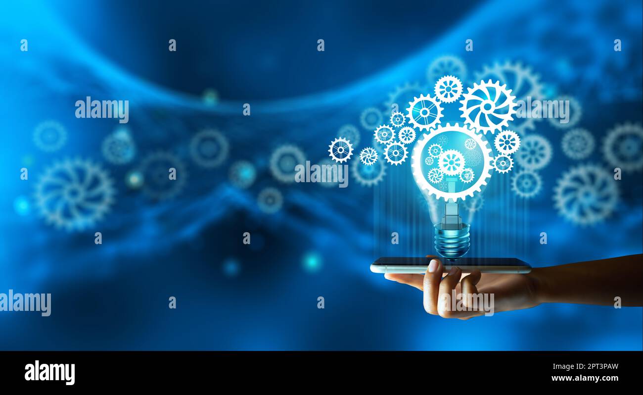 Man hand holding smartphone and Creative light bulb with cog inside and ...