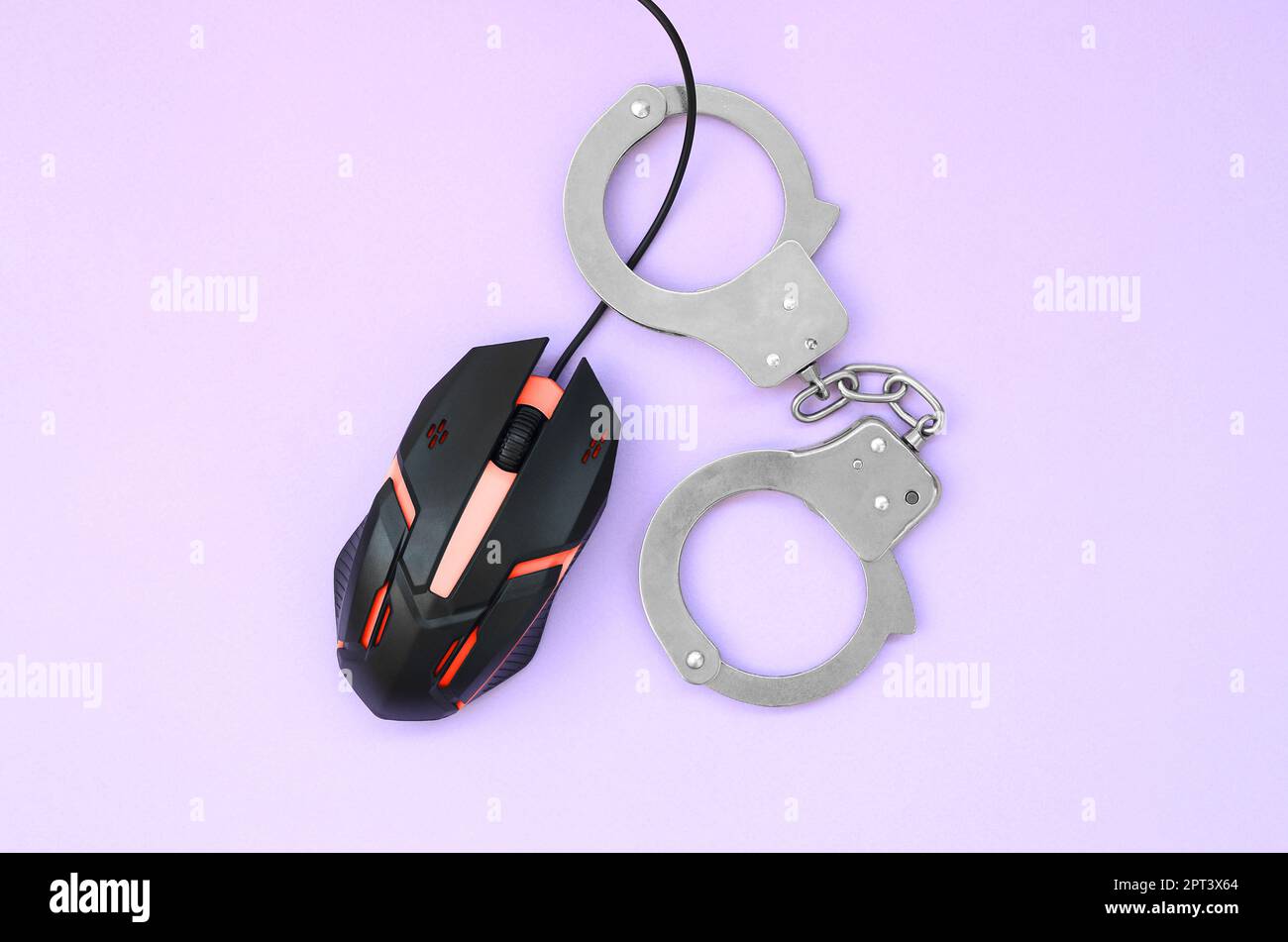 Computer mouse in a red color is chained in handcuffs on the background ...