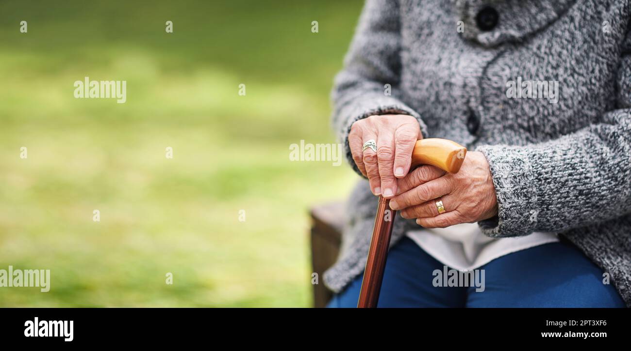 Old woman, hands and cane on park bench or nature in retirement. Senior ...