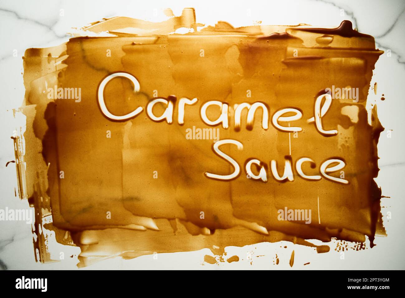 Salted Caramel sauce smeared on the tabletop with the Caramel sauce ...