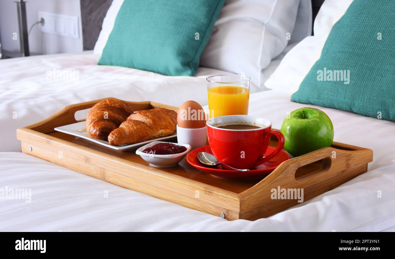 Breakfast on tray in bed in hotel room Stock Photo - Alamy
