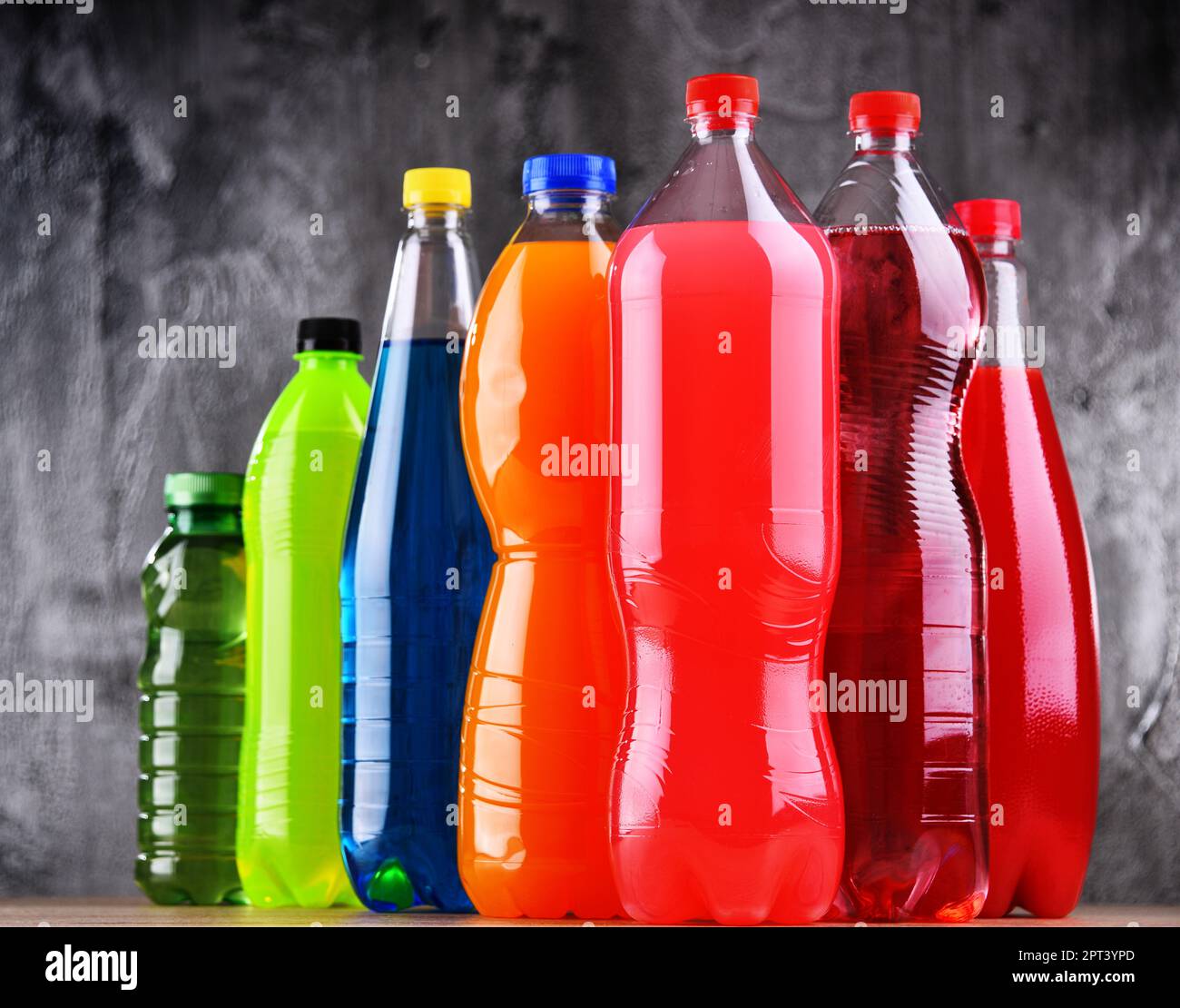 Plastic bottles of assorted carbonated soft drinks in variety of colors ...