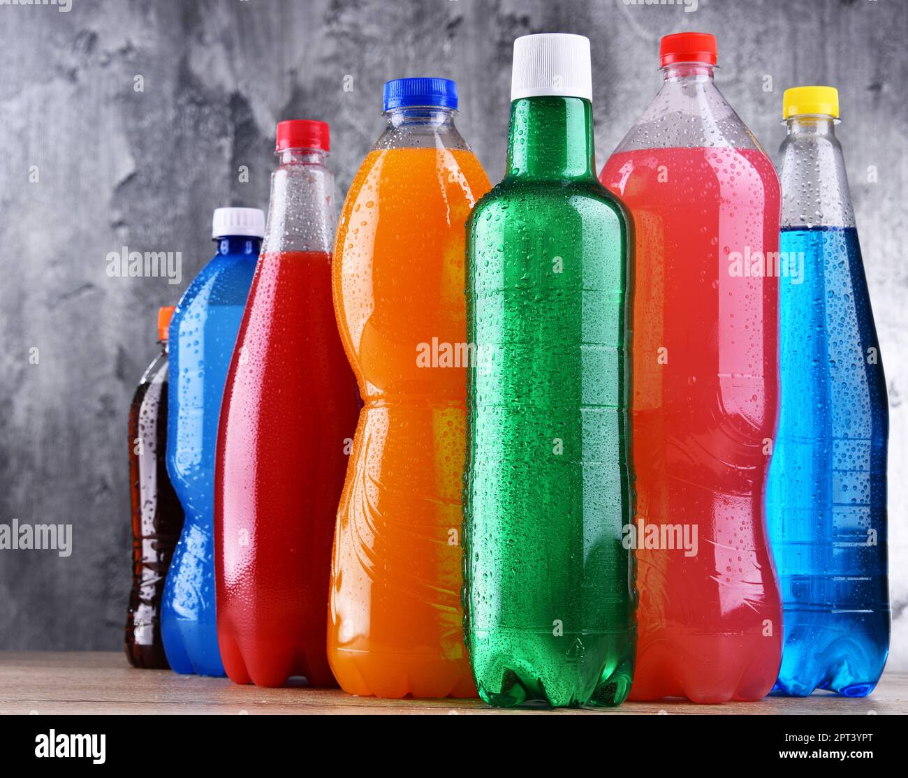 Plastic bottles of assorted carbonated soft drinks in variety of colors ...