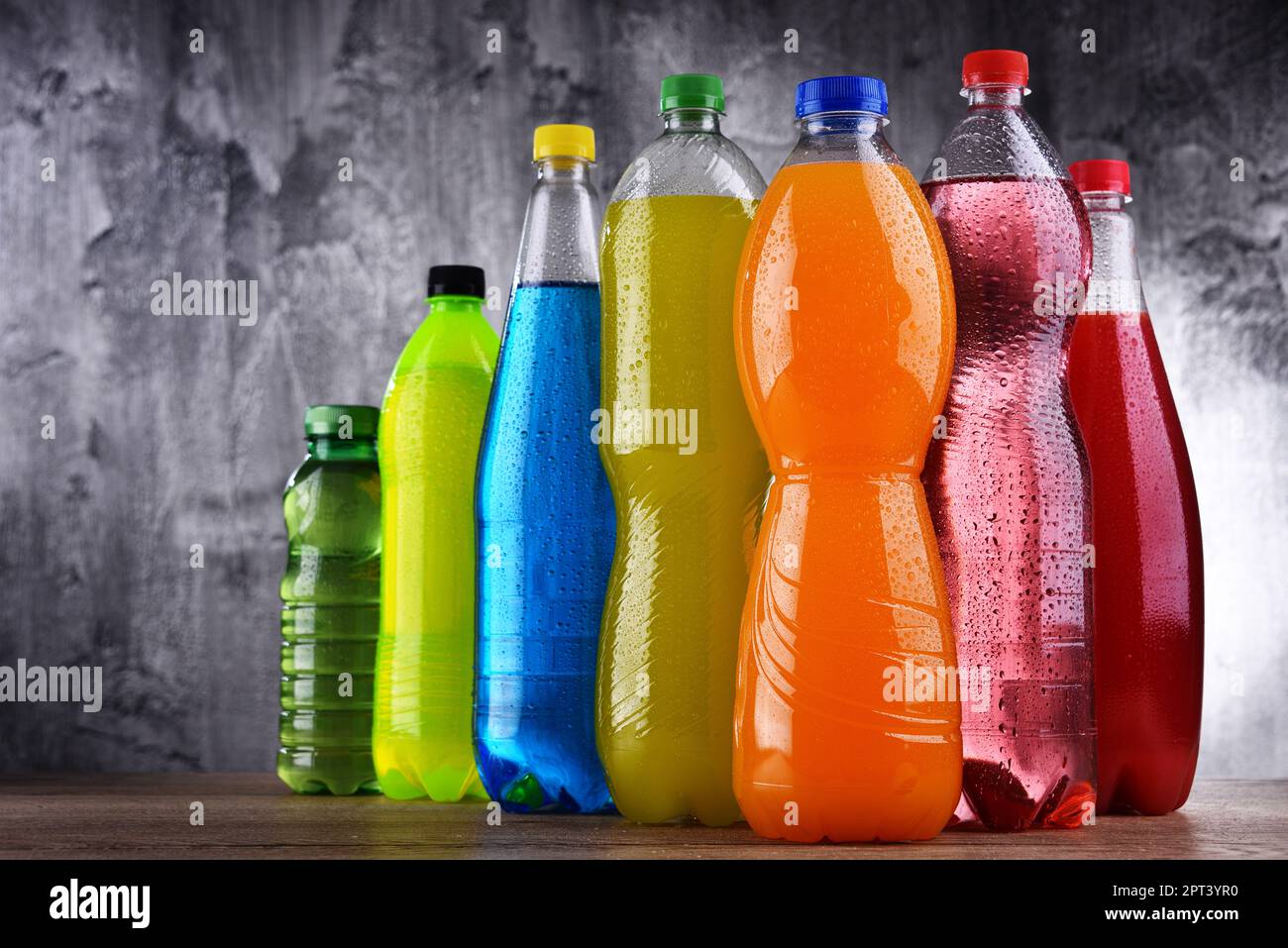 Plastic bottles of assorted carbonated soft drinks in variety of colors ...