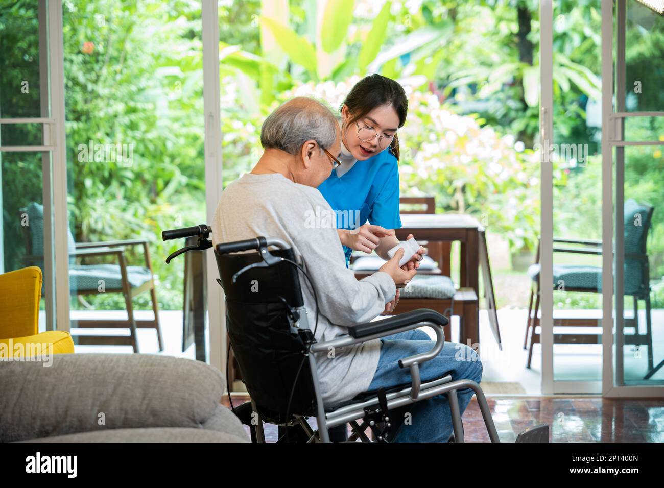 Asian young woman nurse pills with help prescribes medicine to older ...