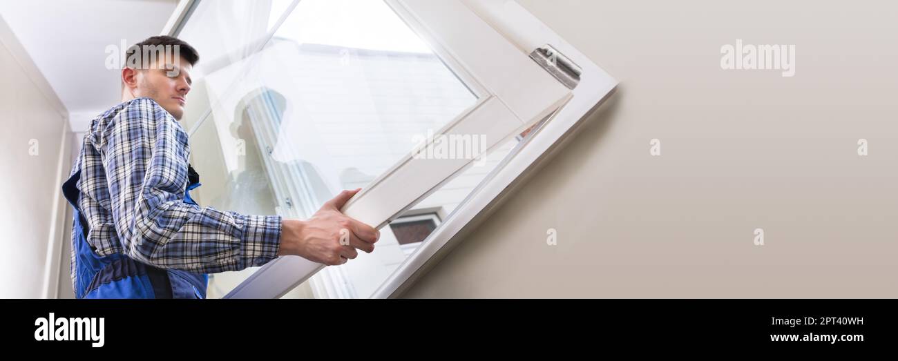 Window Install Service. Man Installing And Fixing House Stock Photo - Alamy