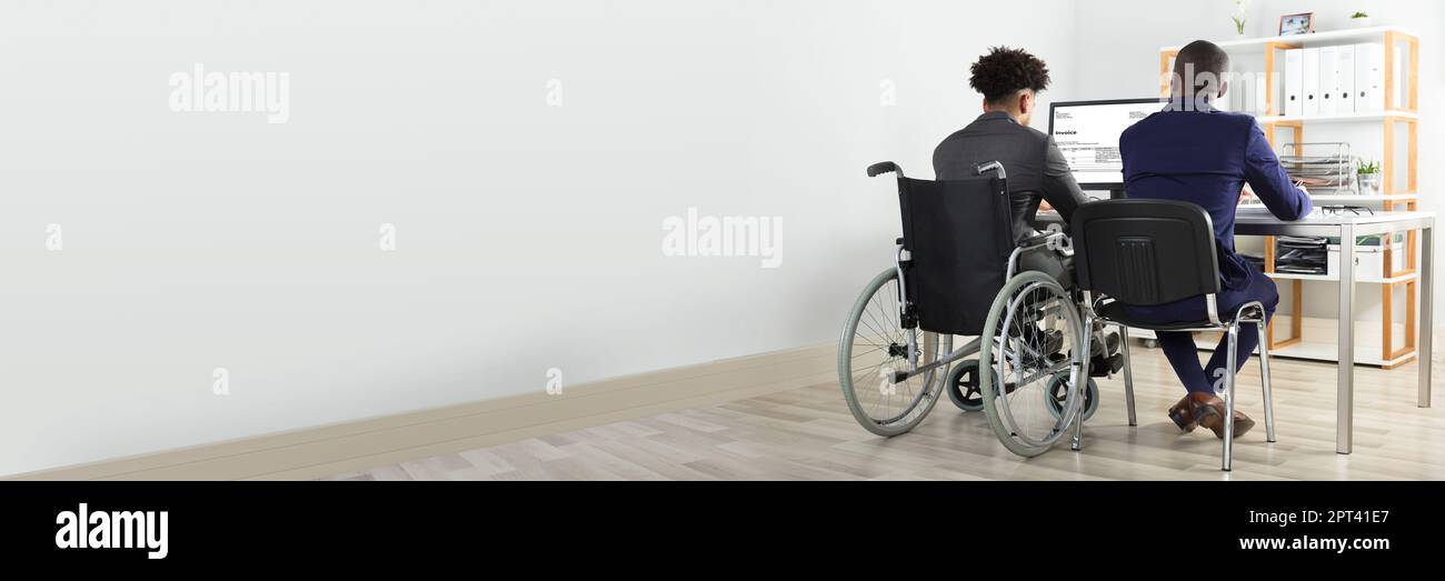 Disabled Worker In Wheelchair At Work Using Computer Stock Photo - Alamy
