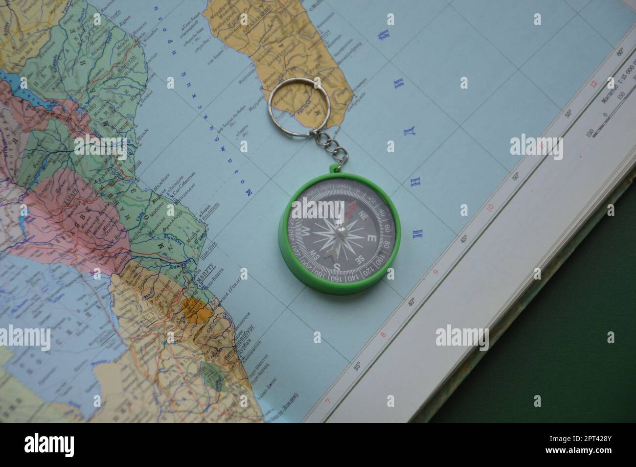 Hand compass for travel on the background of a objects Stock Photo - Alamy