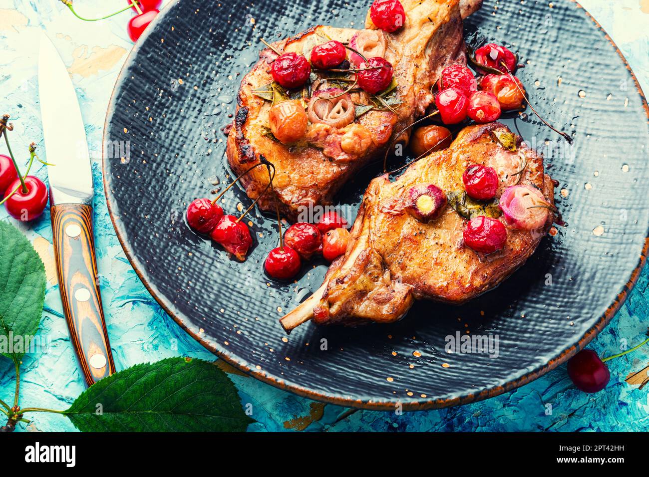 Two cooked steaks in a cherry marinade. Grilled meat with berry sauce ...