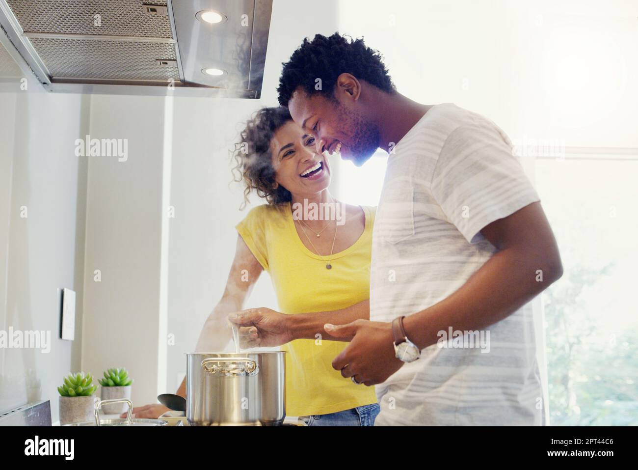Were cooking up a storm together. a young couple cooking together in ...