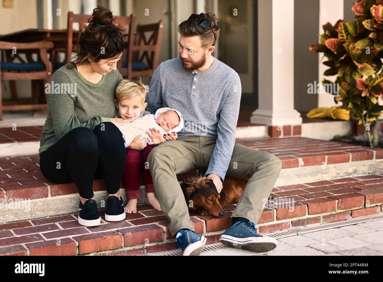 Our family is growing. a young cheerful family standing together ...