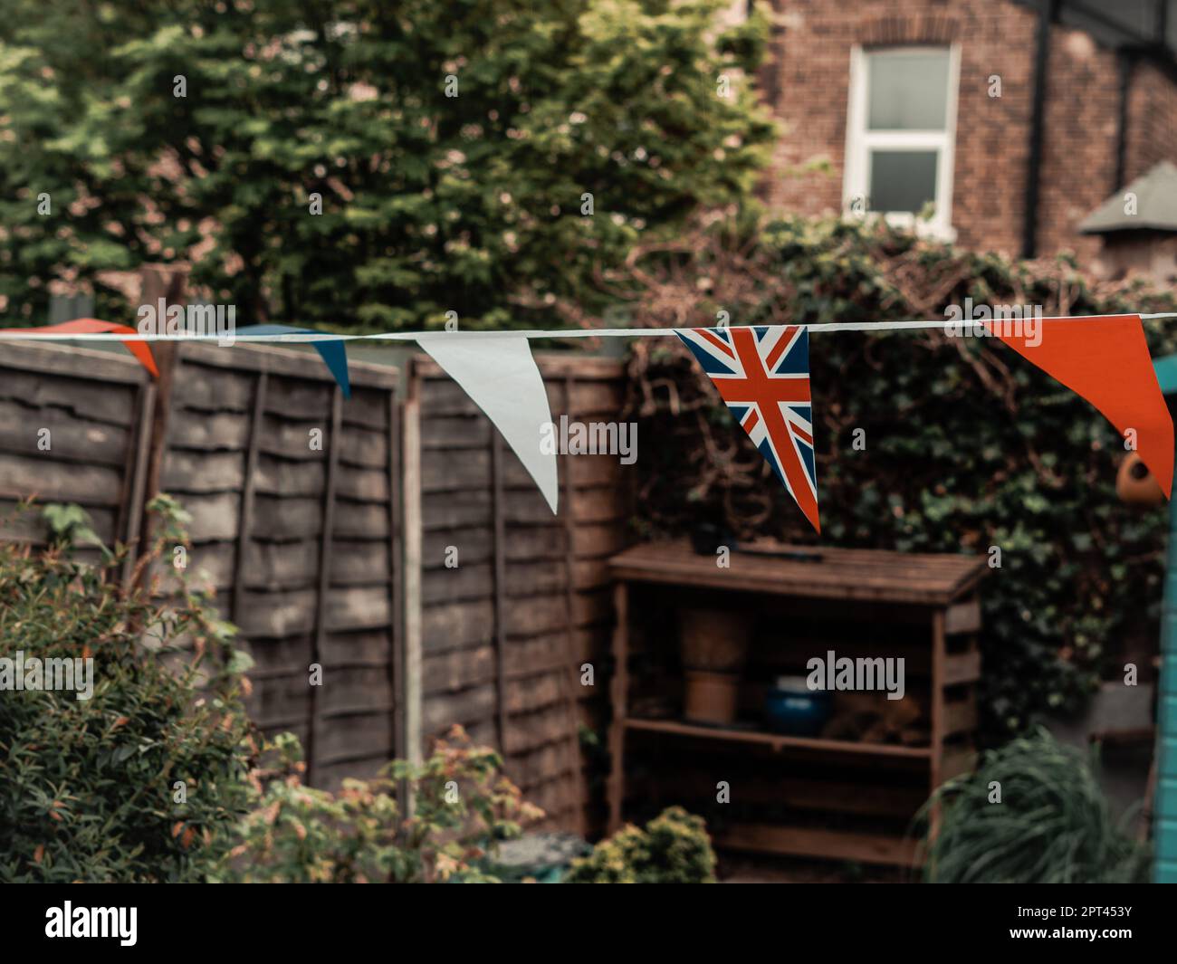 Flags of Great Britain waving on the wind in the garden of English ...