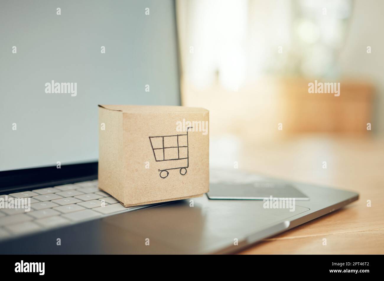 Online shopping, box and laptop with credit card for payment of product, purchase or service ...