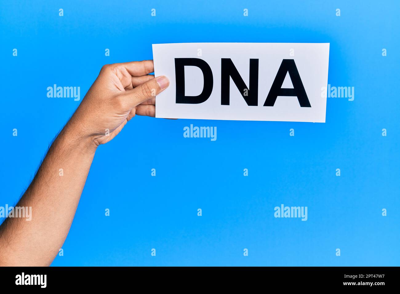 Hand of caucasian man holding paper with dna word over isolated white ...
