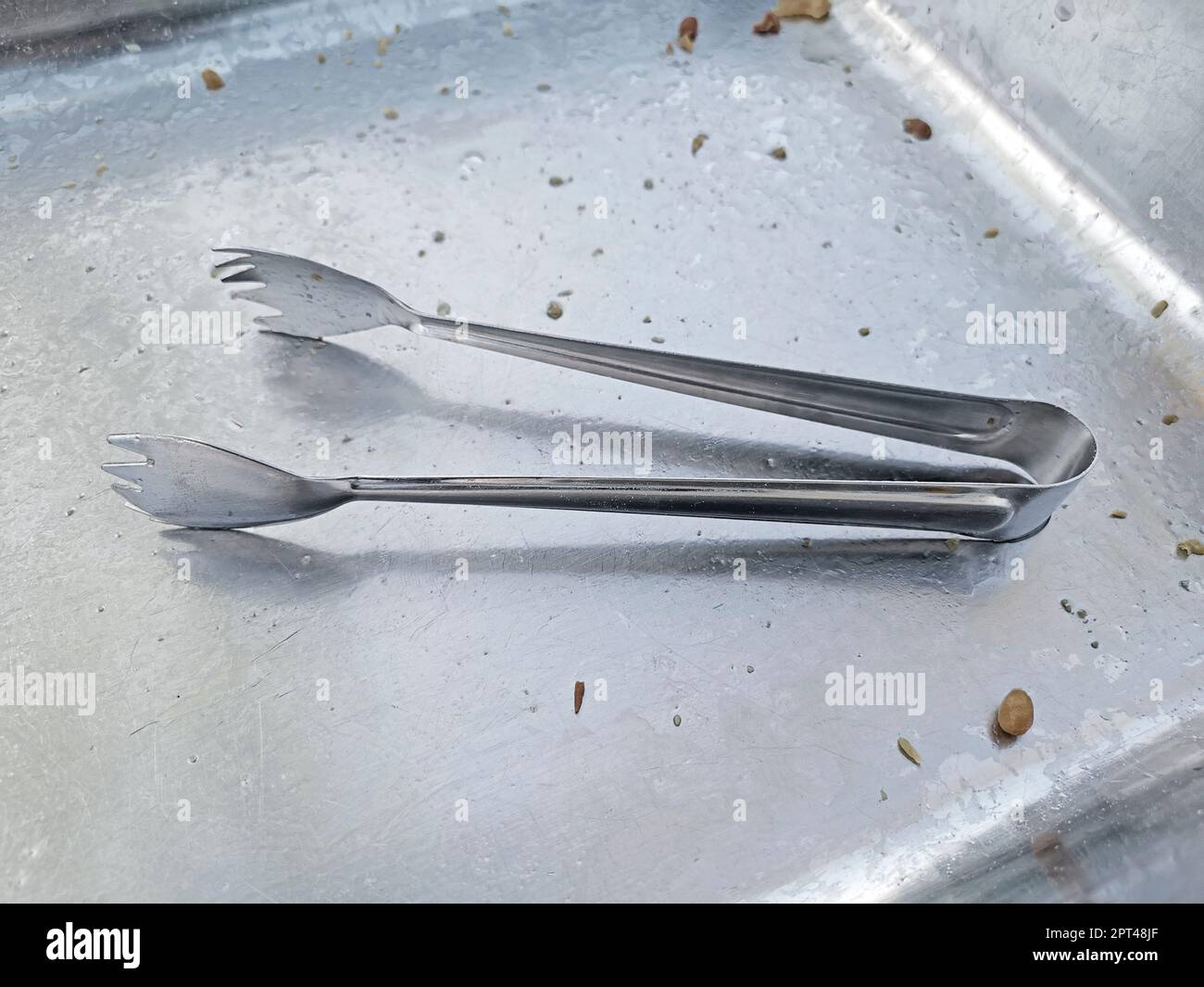 tongs. tongs are a tool for grabbing food, etc Stock Photo - Alamy