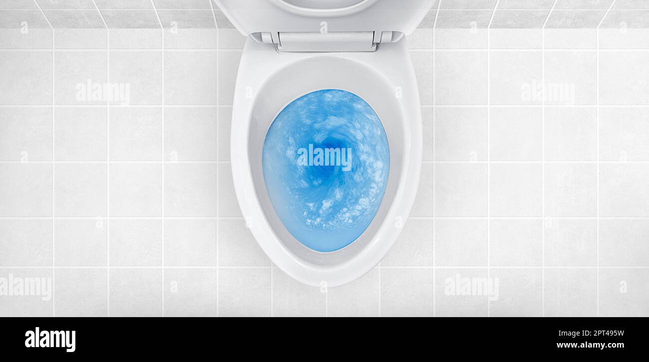 Top view of toilet bowl, blue detergent flushing in it Stock Photo - Alamy
