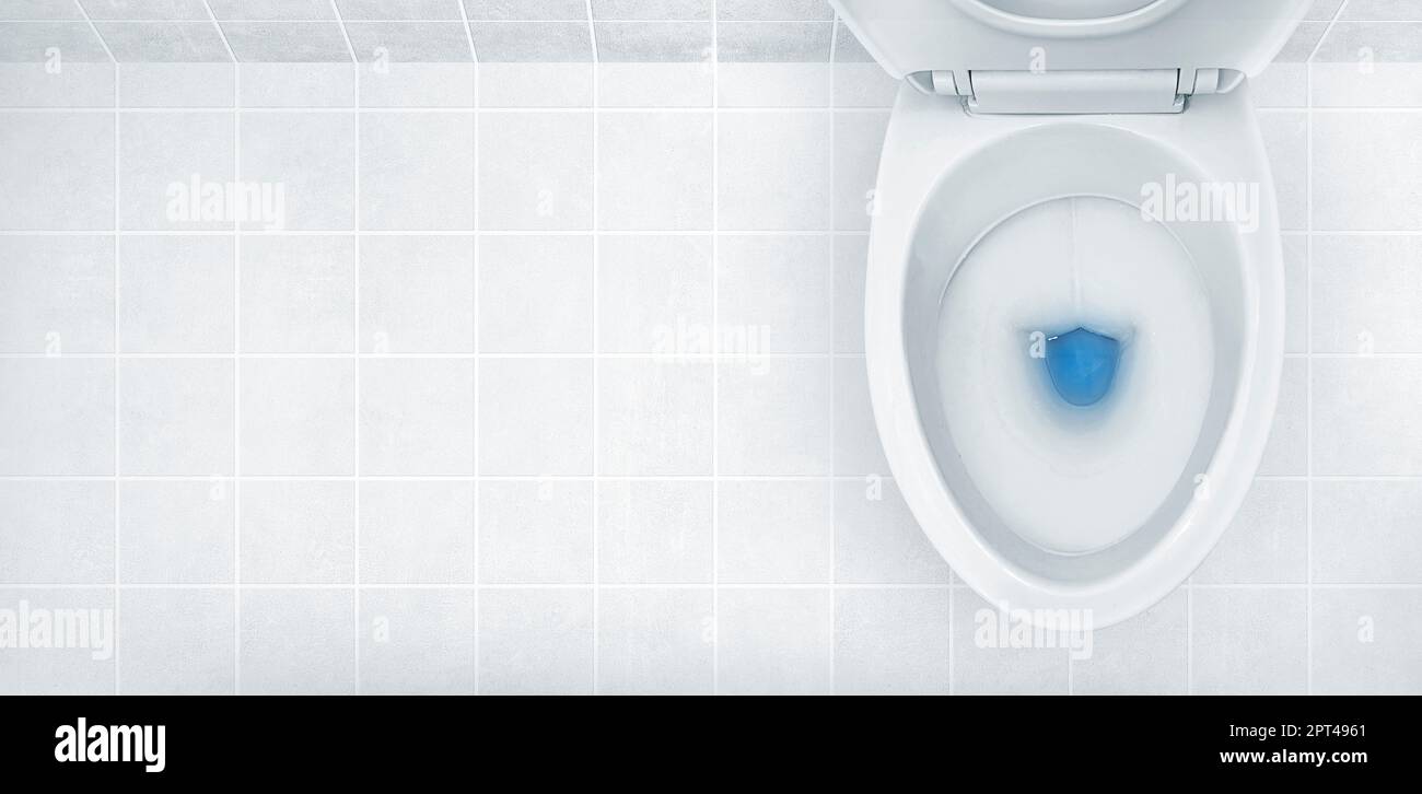 Top view of toilet bowl, blue detergent flushing in it Stock Photo - Alamy