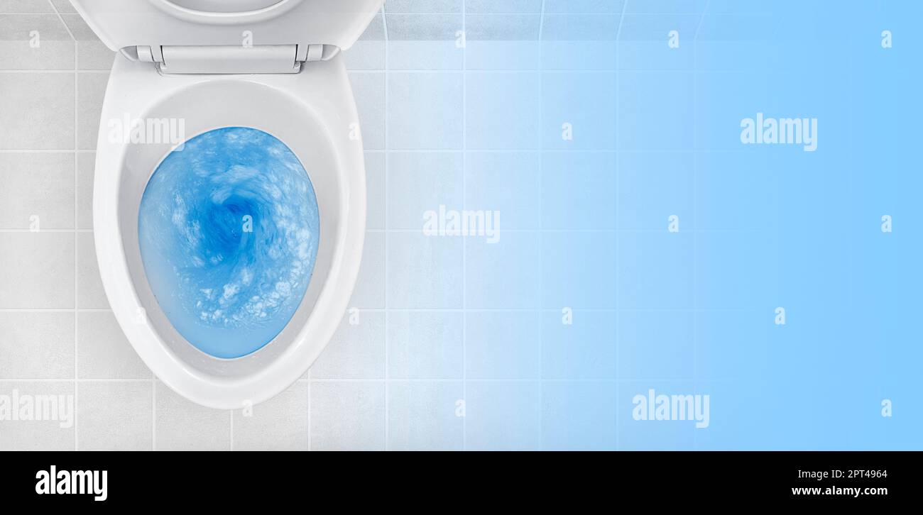 Top view of toilet bowl, blue detergent flushing in it Stock Photo - Alamy