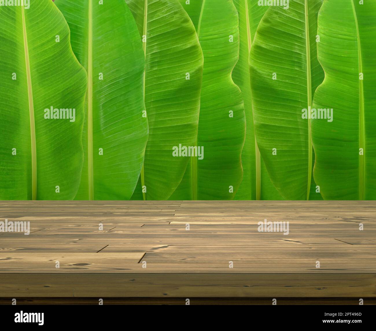 Wooden table with whole fresh banana leaves background Stock Photo - Alamy