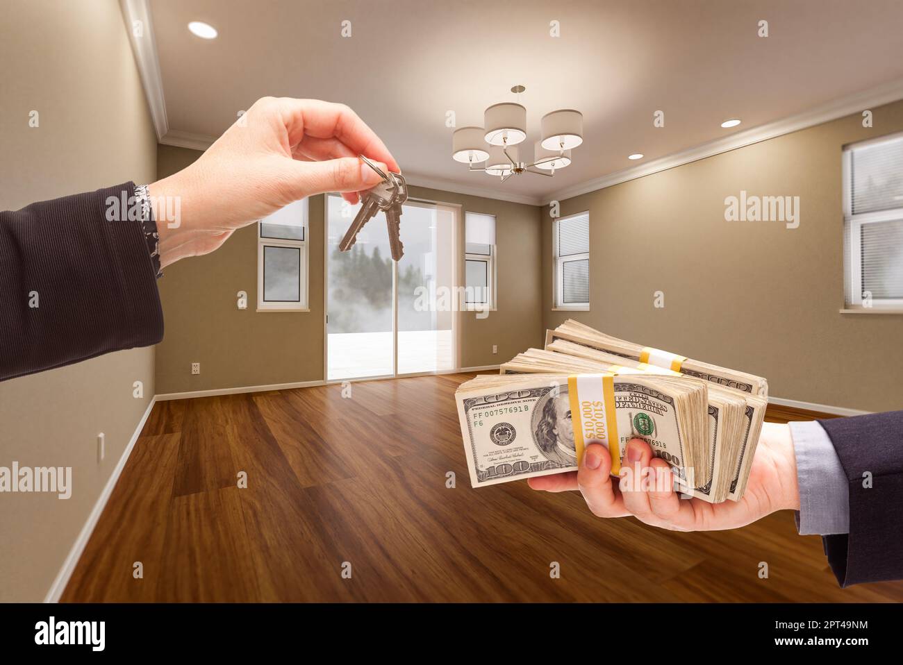 Agent Handing Over House Keys for Cash in Newly Remodeled Room of House ...