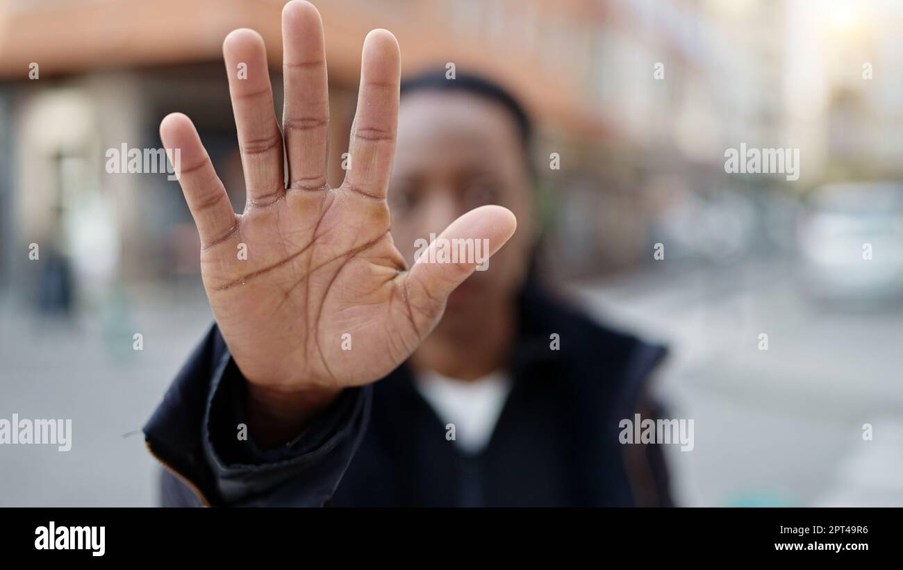 African american woman doing stop gesture with hand at street Stock ...