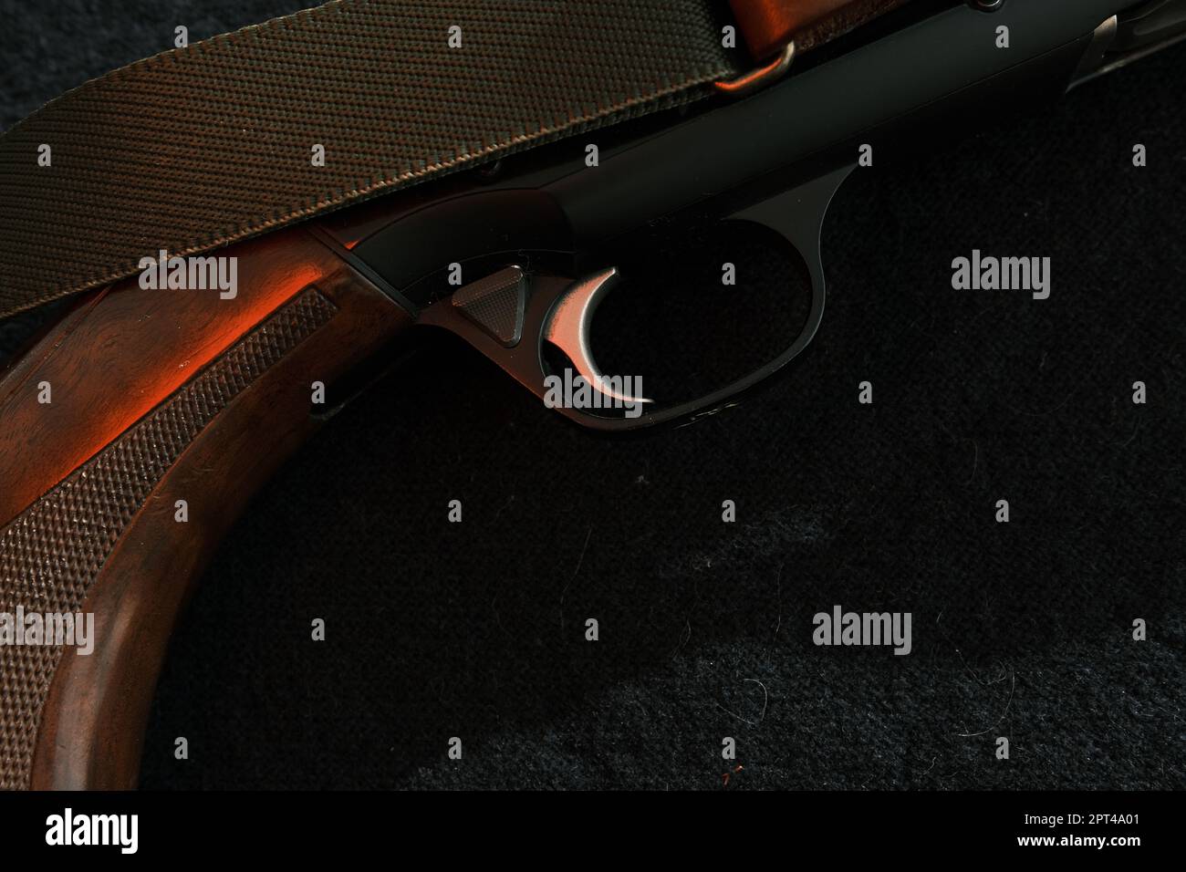 Trigger of a rifle on black background with red lightning Stock Photo ...
