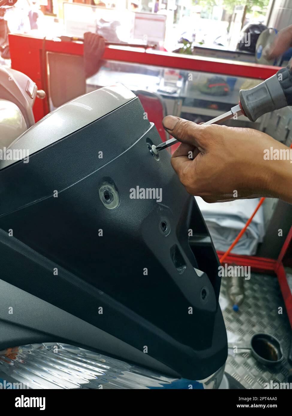 Bike repair. Young man repairing motobike in garage.mechanic fixing motocycle engine.Serious ...