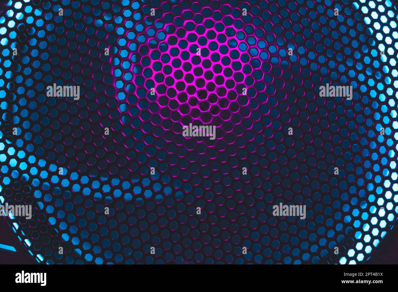 Colorful light of computer fan shines through the holes of protective ...