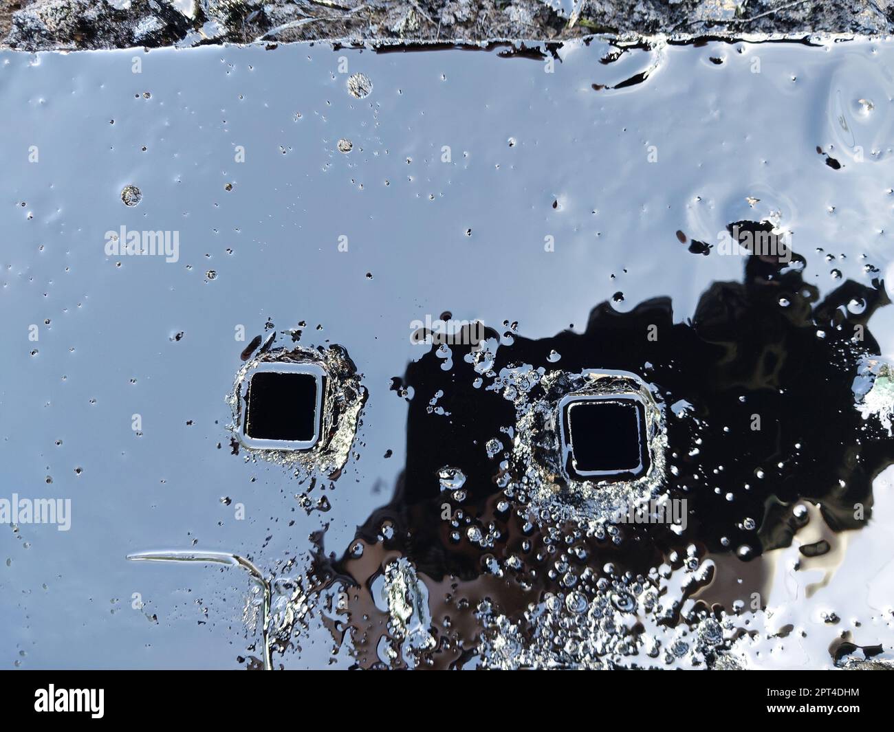 Spraying liquid bituminous mastic on the concrete foundation for the ...