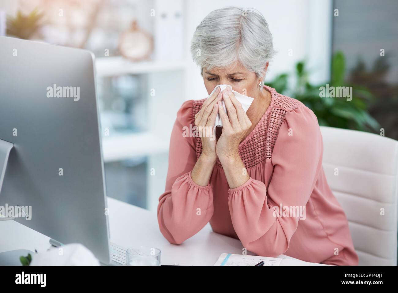 Mature woman office blowing nose hi-res stock photography and images ...