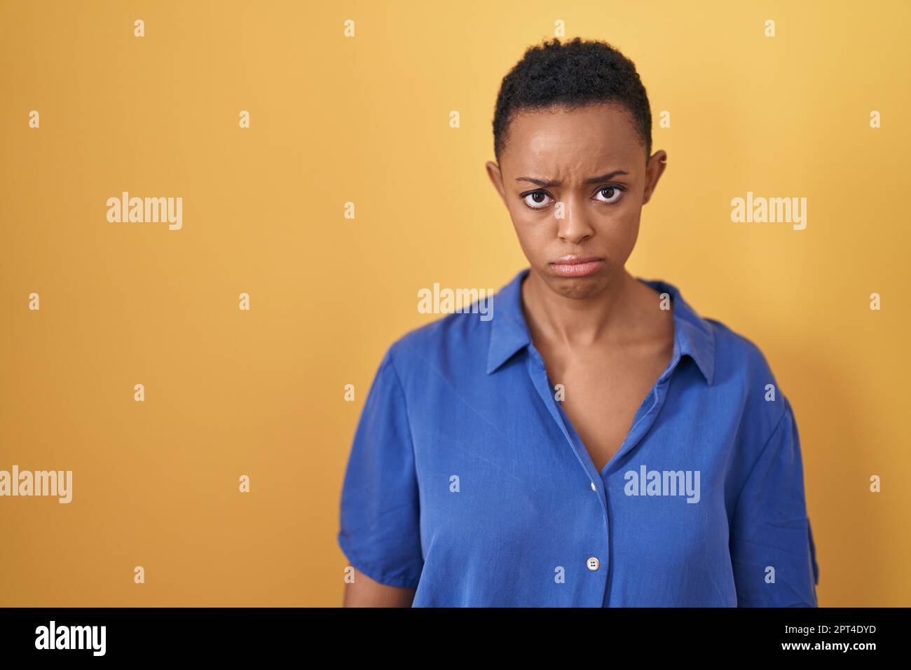African American Woman Standing Over Yellow Background Depressed And