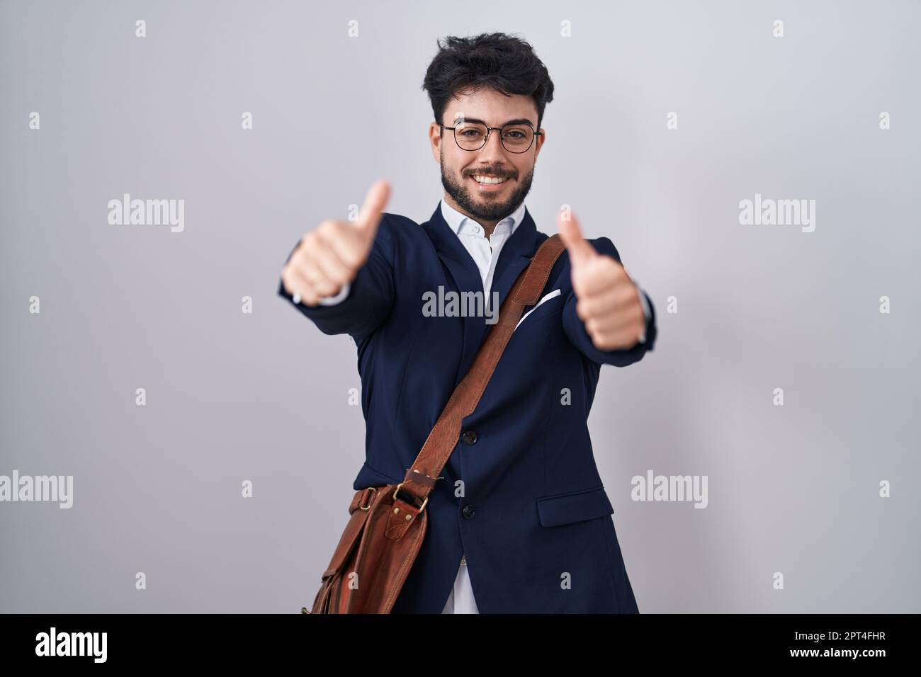 Hispanic man with beard wearing business clothes approving doing ...
