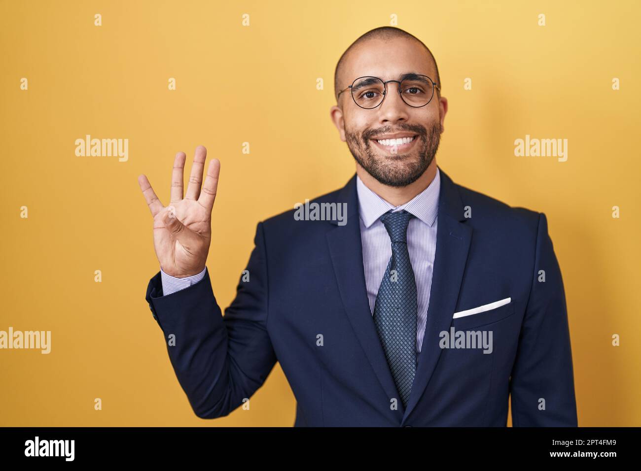 Hispanic man with beard wearing suit and tie showing and pointing up ...