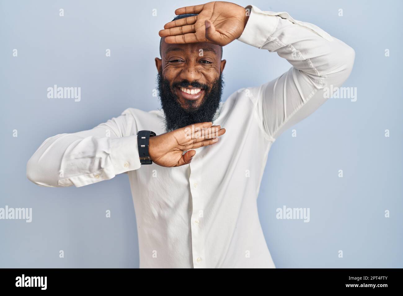 African american man standing over blue background smiling cheerful ...