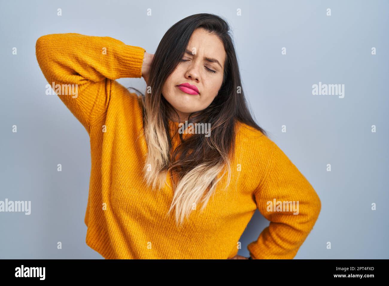 Young hispanic woman standing over isolated background suffering of ...