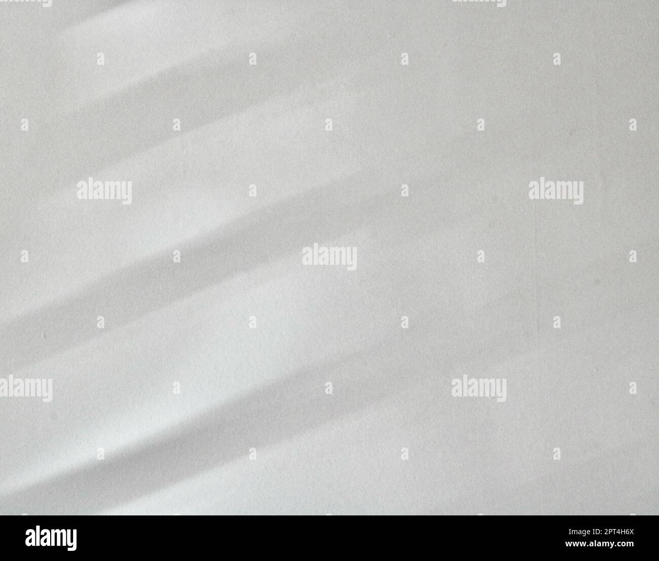 Angled full frame image of light shining through plantation shutters ...