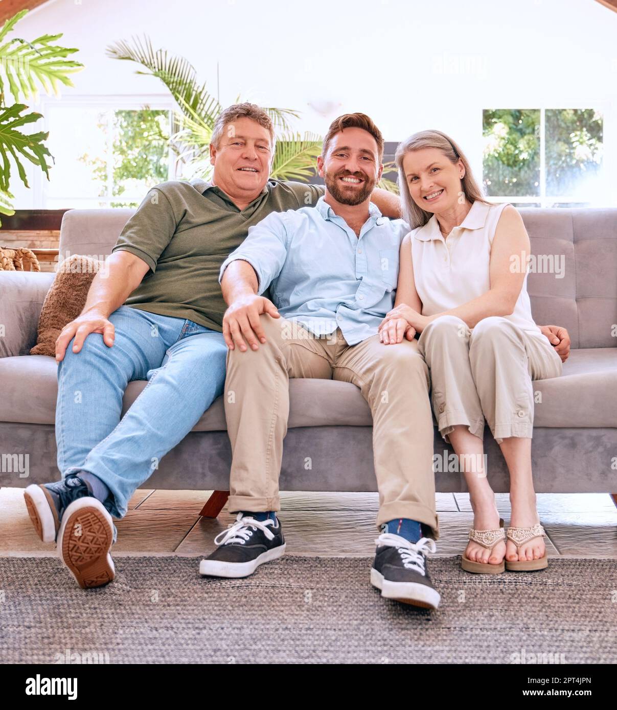 Portrait, mother and father with adult son, happy and bonding together ...