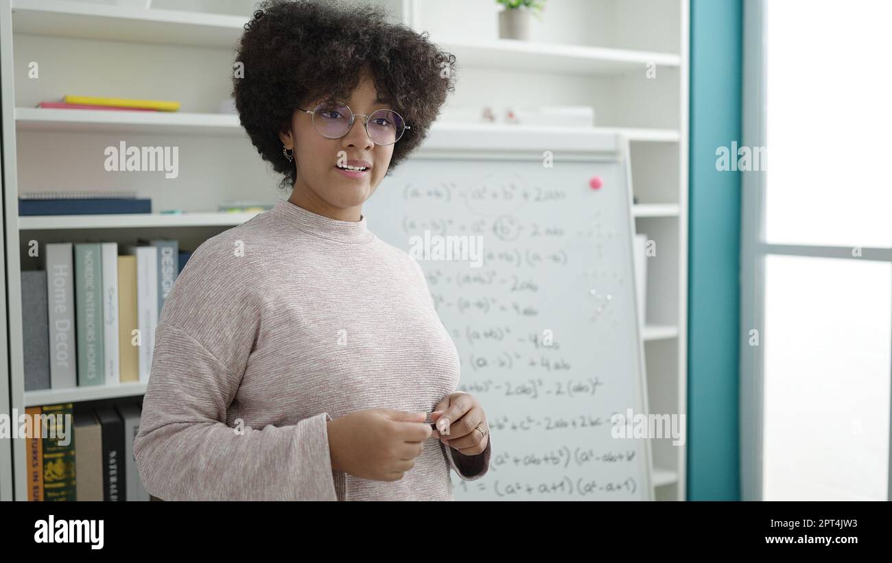 Young african american woman teacher teaching maths lesson at ...
