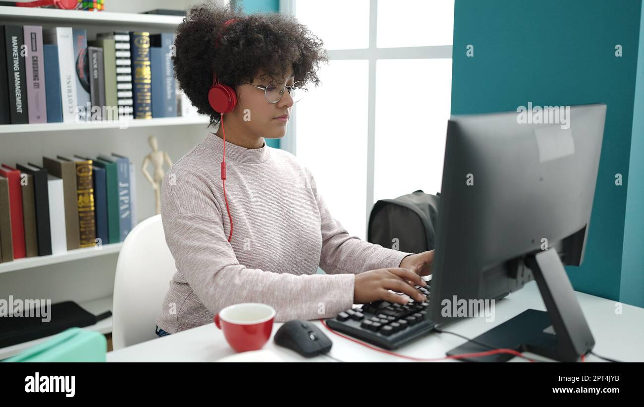 Young african american woman student using computer studying at ...